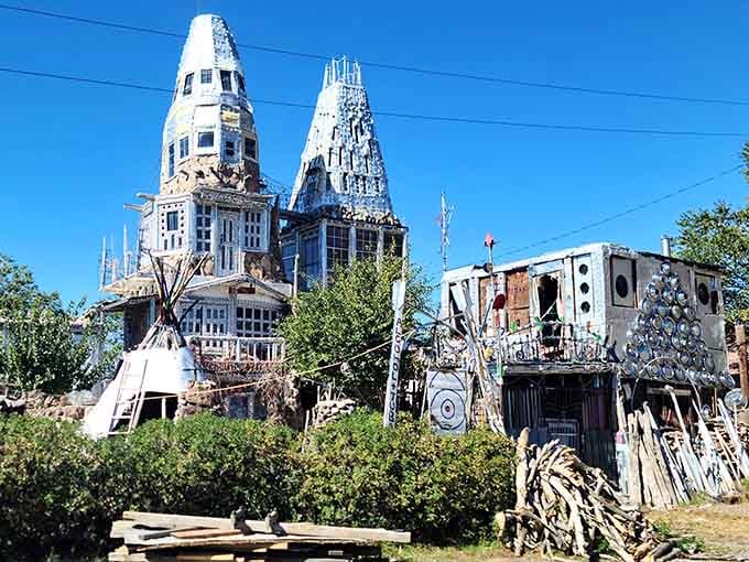 Four shining towers of beer cans and hubcaps, proof that one person's trash is Colorado's treasure.