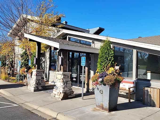 Stone pillars and autumn planters frame the entrance to your next lakeside obsession in Long Lake.