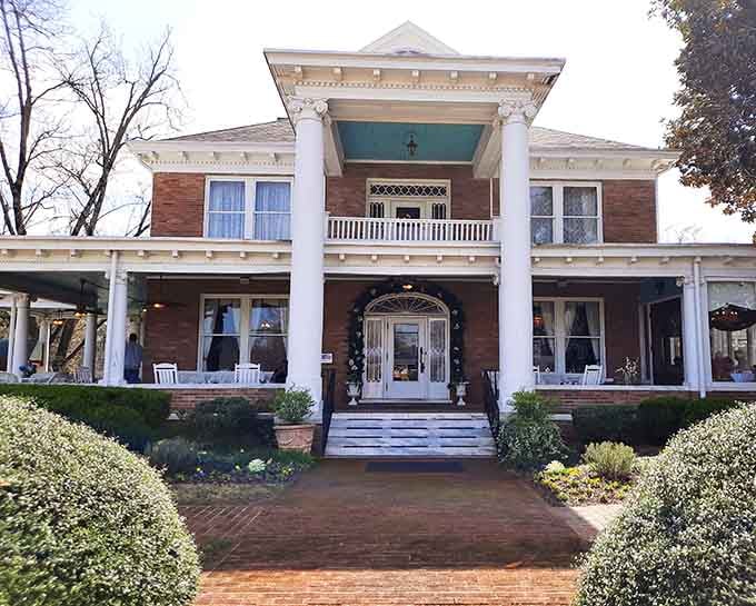 Teal ceiling, white columns, wraparound porch, this Georgian manor means serious business before you even reach the door.