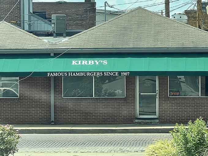 That green awning and bold claim say everything: over a century of legendary burgers, still open for business.