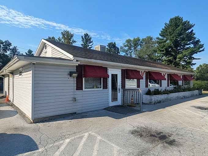 Those deep red awnings against white siding say everything: no fuss, just good food waiting inside.