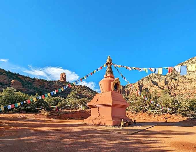 Prayer flags radiate from the stupa's peak, carrying wishes across the desert breeze in every direction imaginable.