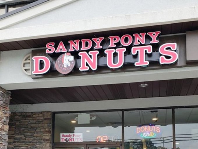 That pink sign isn't subtle, and honestly, it doesn't need to be. Sandy Pony Donuts means business.