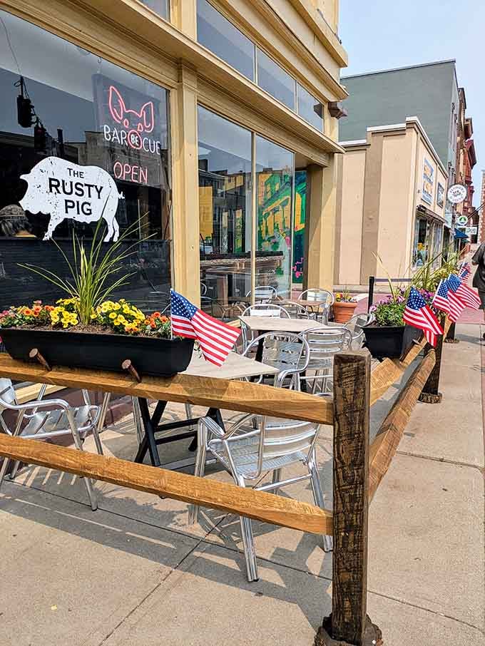Flower boxes, American flags, and a glowing neon pig sign. This place already knows what it's doing.