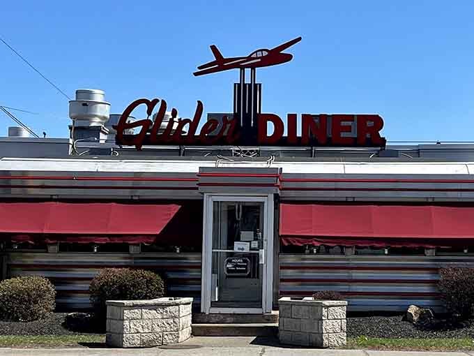 That metal glider perched on the rooftop sign isn't just decoration, it's a promise that something worth landing for is inside.
