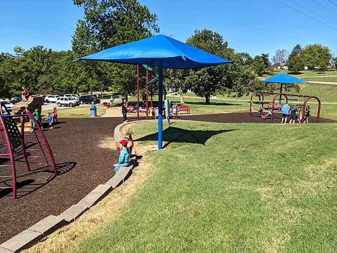 Shade canopies, swings, and pure chaos in the best possible way. Parents on the bench have earned that rest.