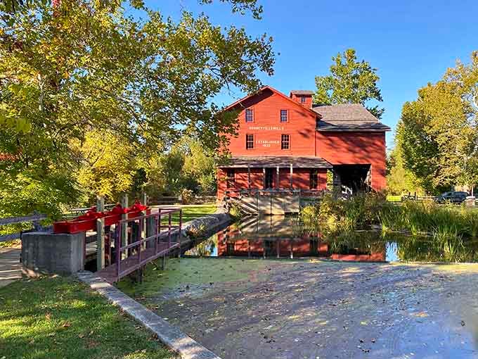 That bold red mill rising from the treeline isn't a painting. It's Bristol, Indiana, doing what it does best.