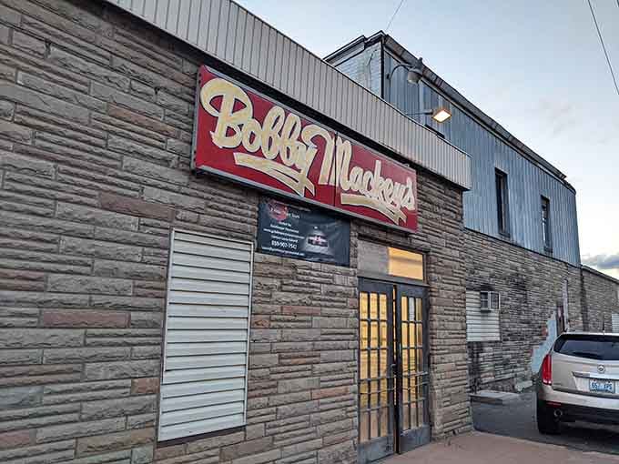 Stone facade and glowing doorway welcome brave souls seeking cold drinks, hot music, and possibly paranormal encounters.