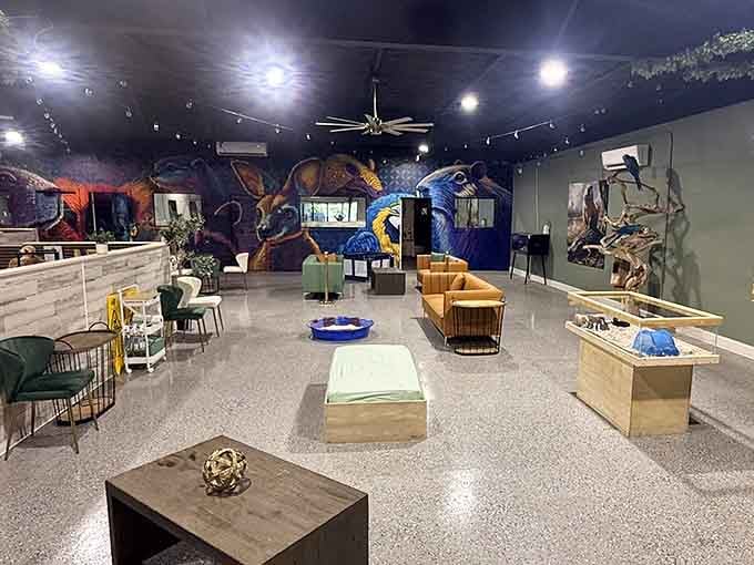 The spacious indoor lounge features cozy seating, unique animal enclosures, and a stunning mural showcasing beautiful wildlife art all around.