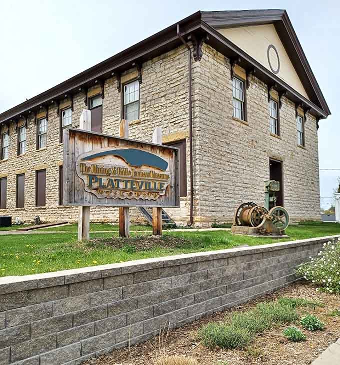 Vintage mining equipment sitting quietly on the lawn hints at the remarkable stories waiting just inside those stone walls.