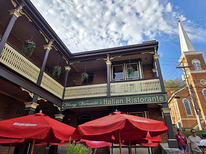 Those red umbrellas signal outdoor dining with a view, because sometimes the best Italian meals happen under open skies on a historic Galena balcony.
