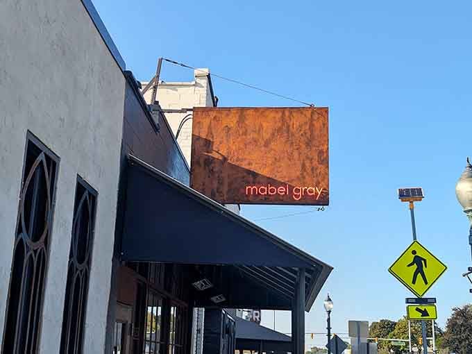 That weathered exterior with the glowing sign isn't trying too hard, and that's exactly why it works perfectly.