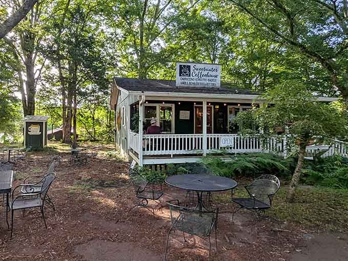 Tucked beneath a canopy of trees, this dark green cottage proves the best things in life require a little searching.