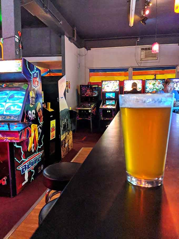 A cold pint at the bar, pinball machines glowing in the background. Life is good.
