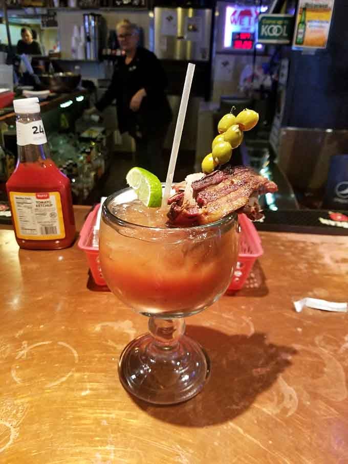 A Bloody Mary garnished with bacon because apparently someone in the kitchen understands what dreams are made of.