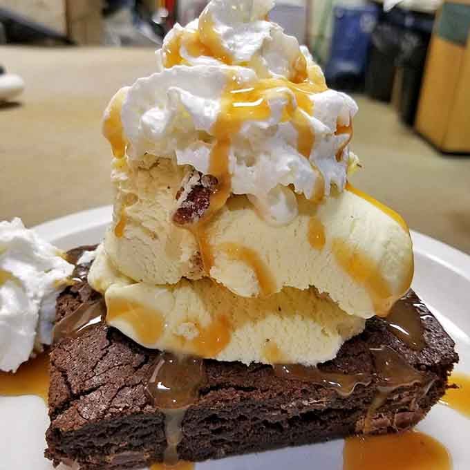 A brownie topped with ice cream, whipped cream, and caramel. Dessert just raised its hand and said, "Pick me."