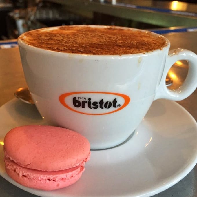 A proper cappuccino with a delicate macaron proves the French understand that coffee deserves a sweet companion.