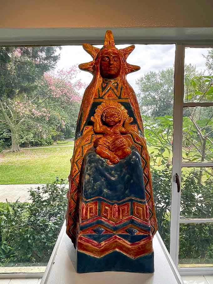 Rich glazed ceramic in amber, cobalt, and red. This Madonna and Child piece glows like a stained glass window in sunlight.