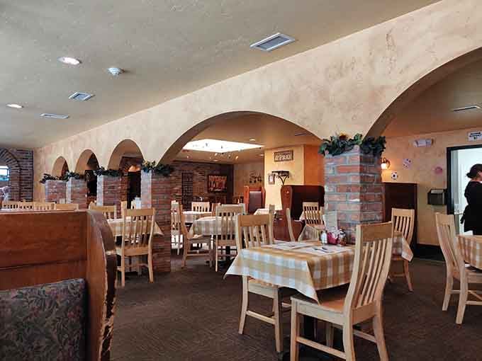 Arched ceilings, brick columns, and checkered tablecloths. This dining room feels like a warm hug you didn't know you needed.