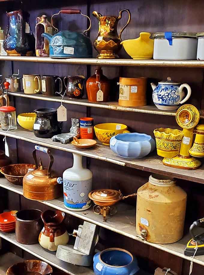 Vintage pottery and kettles stacked with the kind of quiet charm that modern kitchens desperately wish they had.