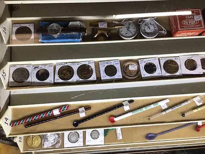 Coins, pocket watches, and old stirring rods, tiny objects carrying decades of quiet, unhurried American history in their worn surfaces.