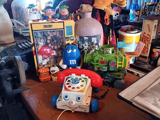 A Fisher-Price chatter telephone and an M&M clock sharing shelf space, because childhood nostalgia deserves good company.