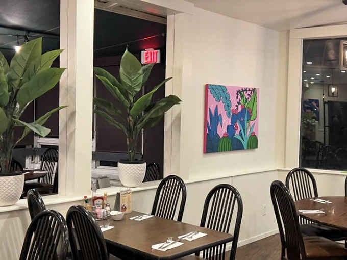 Bold cactus paintings and lush tropical plants share the same wall. Arizona and the tropics, surprisingly good roommates.