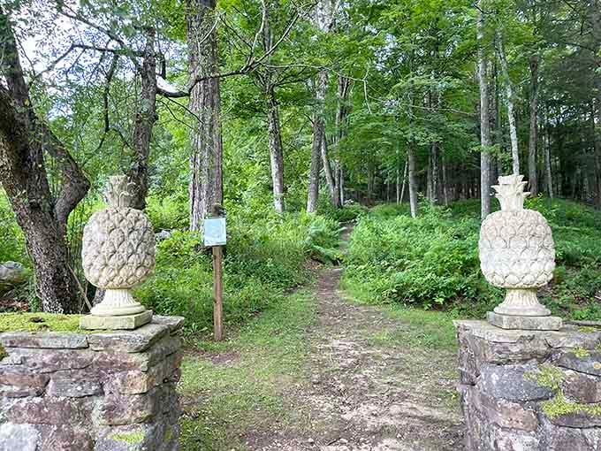Stone pineapple finials marking the garden entrance, the universal symbol of welcome, standing guard since long before anyone had a welcome mat.