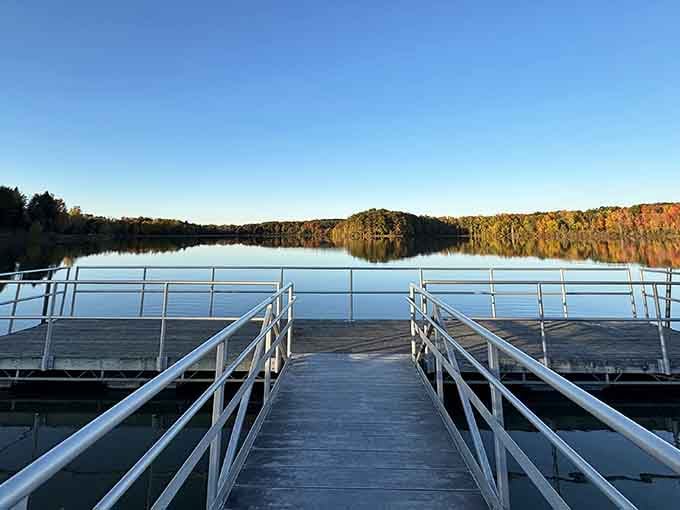A fishing pier stretching out over glassy autumn water, where the view alone is worth the trip.