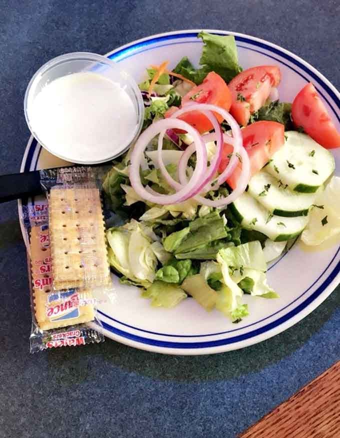 Fresh, crisp, and loaded with tomatoes, cucumbers, and red onion. Even the salad here looks like it showed up to impress.