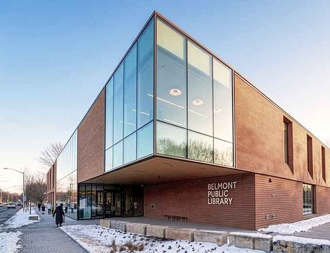 Contemporary library design blending brick warmth with modern glass, proving books and architecture both deserve beautiful covers.