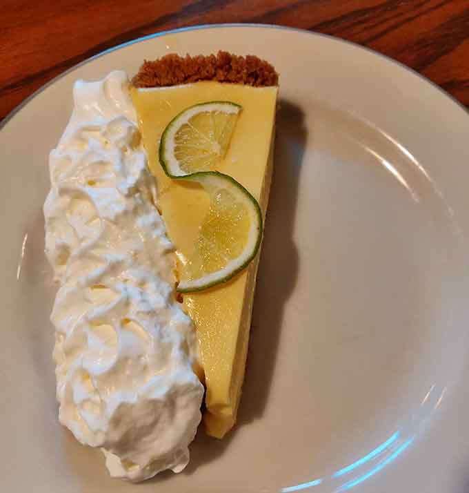 Key lime pie with a graham cracker crust and fresh lime slices. Bright, tangy, and completely worth saving room for.