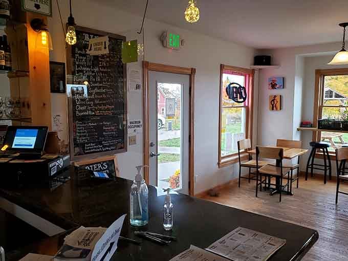 Cozy interior, warm lighting, local art on the walls, and a chalkboard full of reasons to stay longer than planned.