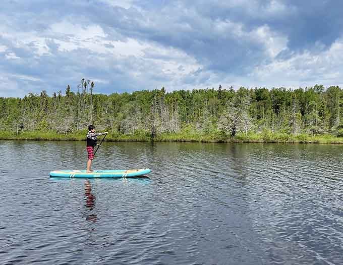Stand-up paddleboarding on the lagoon with a forest backdrop. Somebody pinch this person, they've earned it.