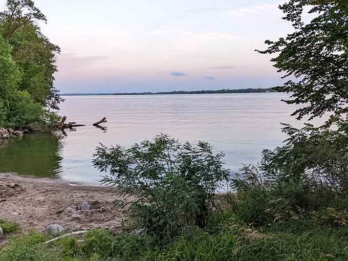 That calm water and soft pink sky are basically nature sending you a very personal invitation to slow down.