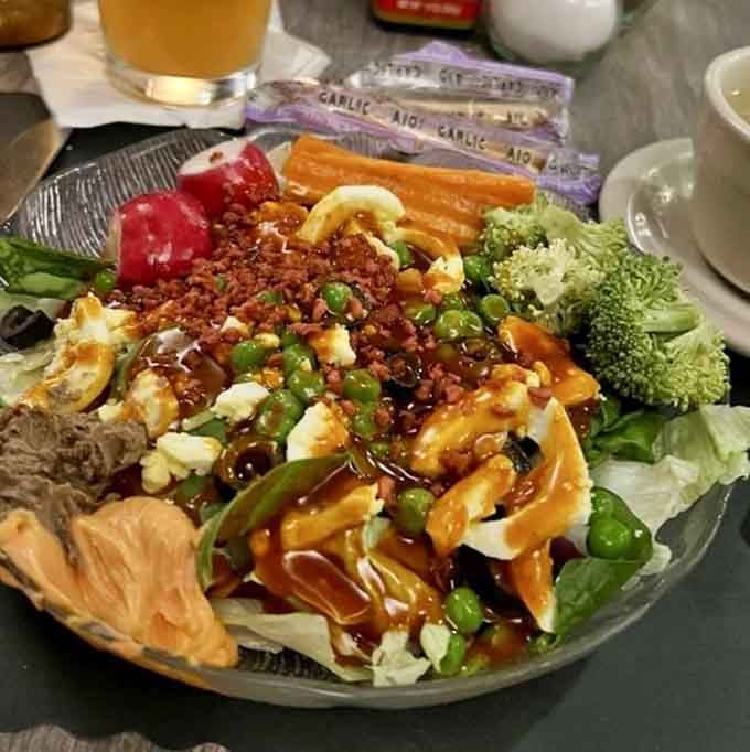 A salad bar this loaded with fresh vegetables, bacon bits, and toppings deserves its own standing ovation tonight.