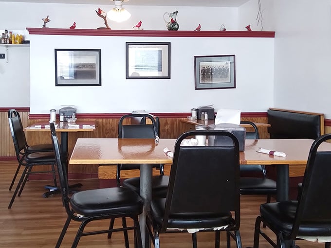 Cardinal figurines perched along the ledge, framed photos on the walls, and clean wooden tables. This room has genuine personality.