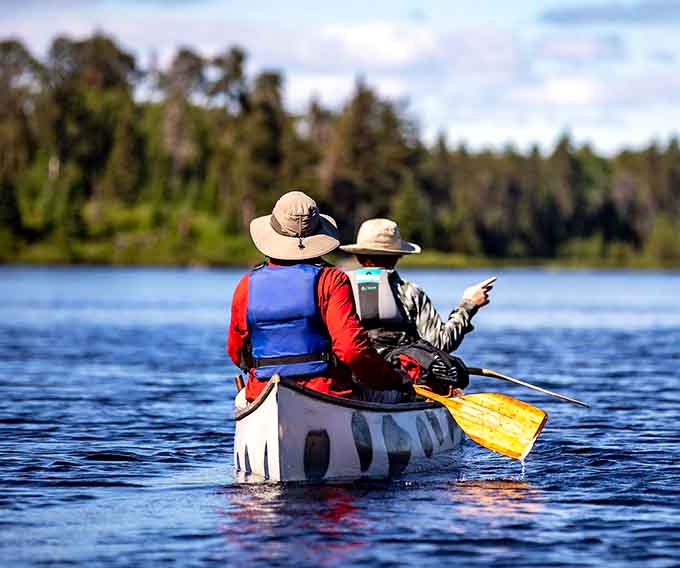 Two paddlers, one direction, and nothing but open water and possibility stretching out ahead of them.
