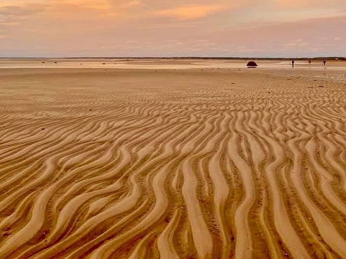Low tide reveals the full spectacle of the Brewster Tidal Flats, a vast sandy canvas stretching toward the bay.