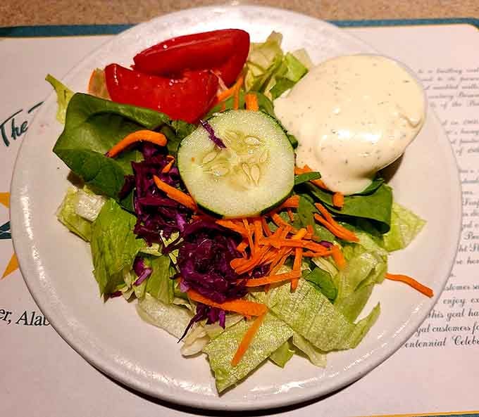 A fresh, colorful salad with creamy dressing, the kind of starter that makes you feel virtuous before the snapper arrives.