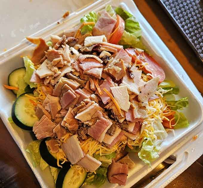 When the salad at a BBQ joint comes loaded with smoked chicken, ham, and turkey, you know this place respects everyone.