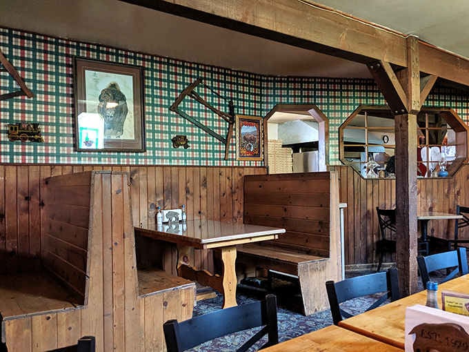 Solid pine booths, plaid walls, and framed artwork. This dining room has genuine, unhurried mountain personality.