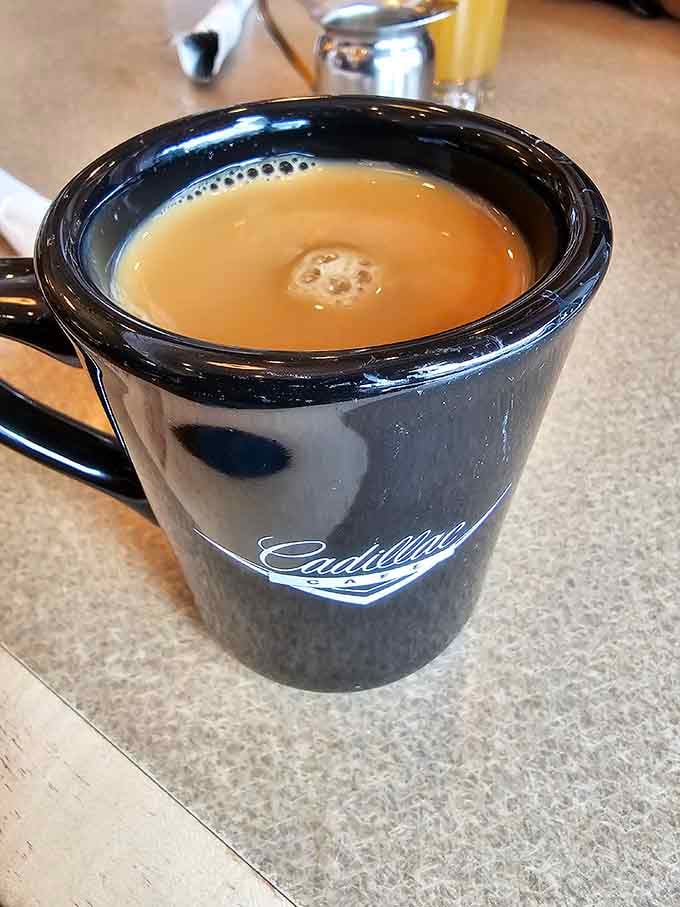 Coffee served in a classic mug with the Cadillac logo, because even your morning joe deserves some style.