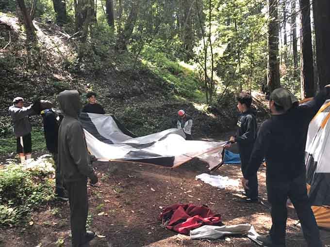 Teamwork makes the tent work. Even the setup process becomes an adventure when the forest is your backyard.