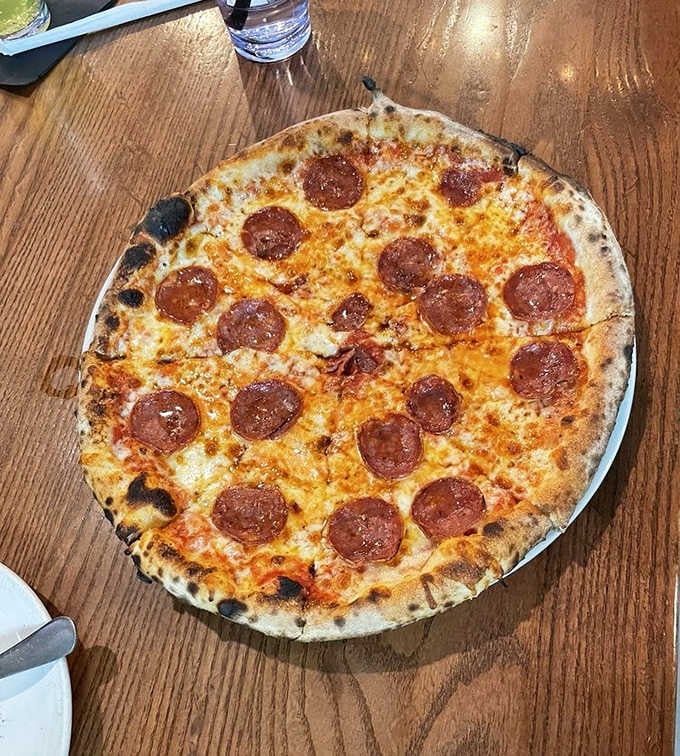 Behold the Sopressata Hot Honey pizza, where sweet meets spicy in a wood-fired masterpiece you'll dream about.