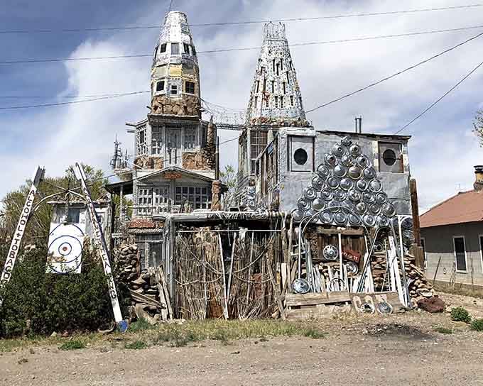 The full front view of Cano's Castle, where hubcaps, scrap metal, and sheer determination created something Colorado should be very proud of.