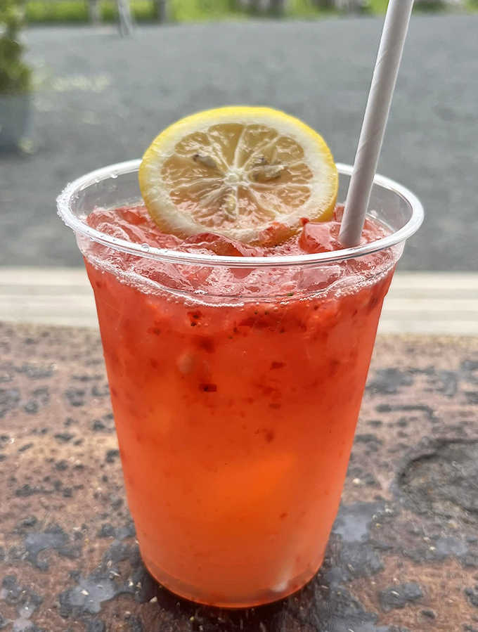 Strawberry lemonade with fresh fruit adds refreshing sweetness to your seafood feast under summer skies.