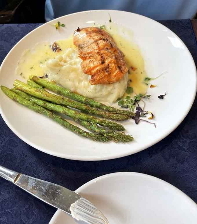 Salmon cooked to perfection with asparagus that actually has color, proving vegetables don't have to be an afterthought at fine restaurants.