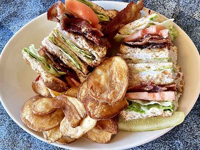 A towering club sandwich with house-made chips proves lunch deserves as much attention as breakfast gets.