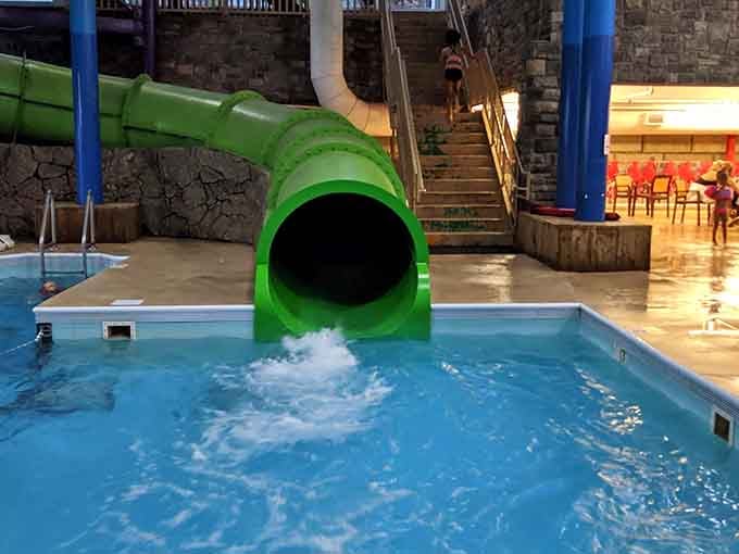 That green tube slide means business, and the splash at the bottom is your reward.